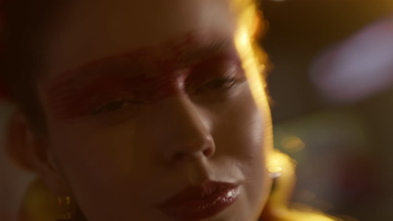 Artistic portrait with dramatic lighting and makeup - Free Stock Video