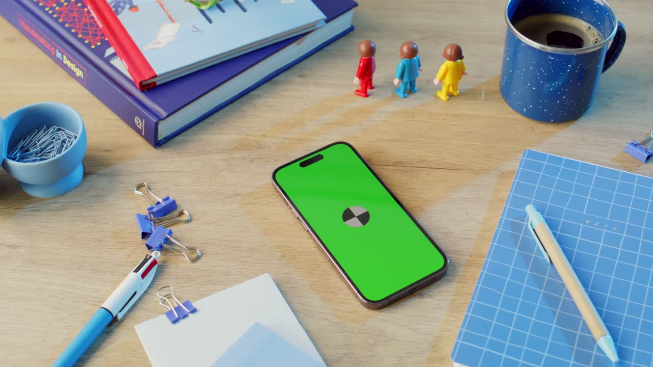 Colorful desk with phone, books, and mini figurines - Free Stock Video
