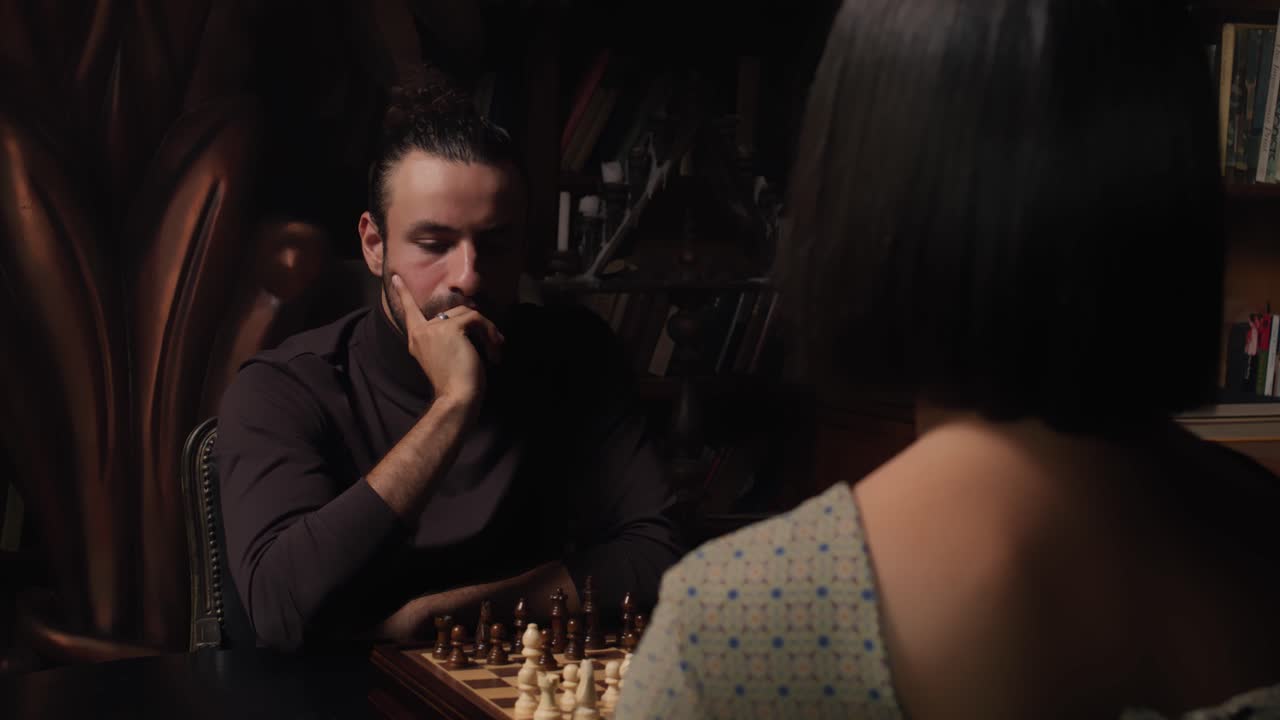 Friends Playing Chess in Cinematic Light - Free Stock Video