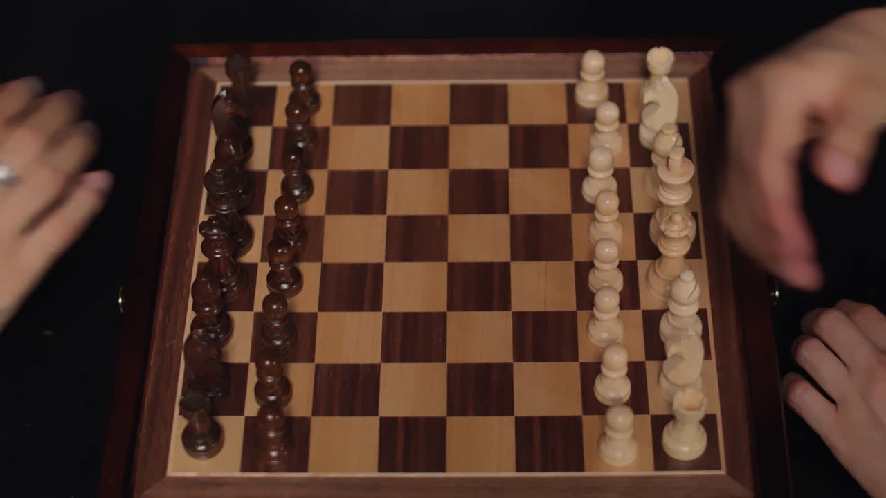 Before maneuvering the pieces two hands perform a handshake over a ...