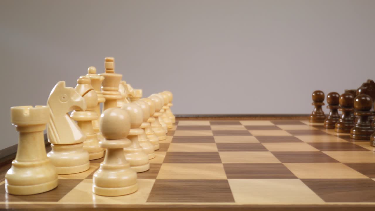 The panoramic shot reveals the two chess teams with the pieces facing ...