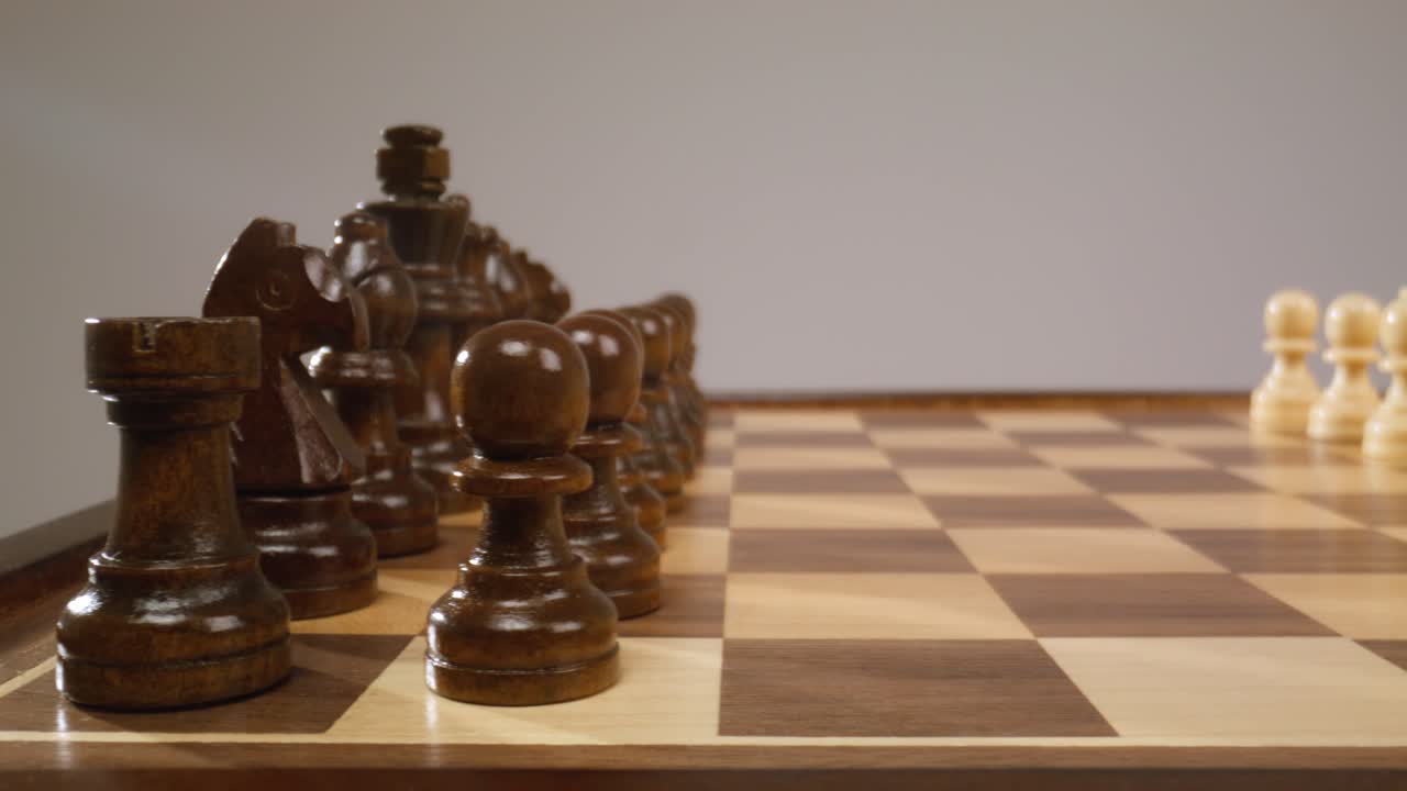 The camera glides steadily along a chess board featuring both sides ...