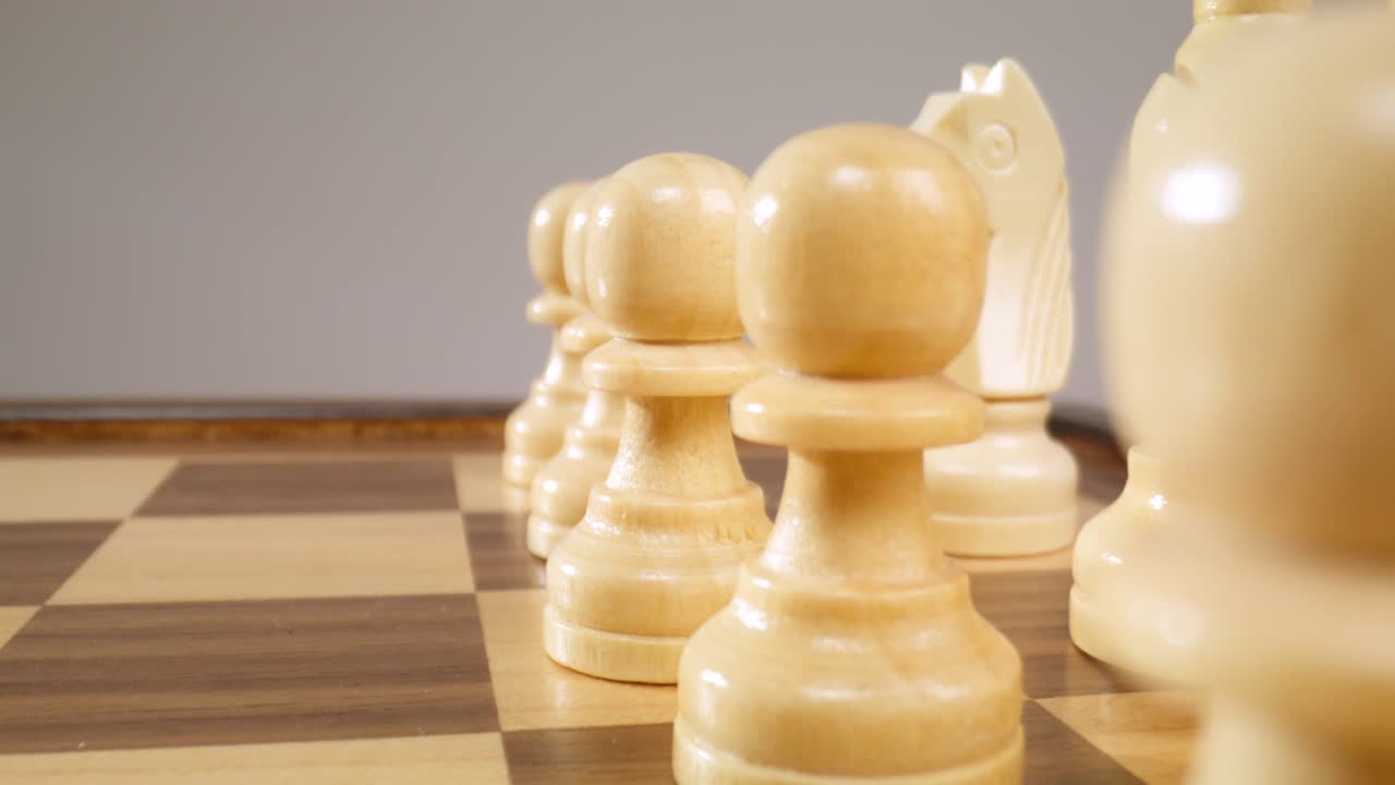 The camera glides backwards capturing the white chessboard pieces in ...