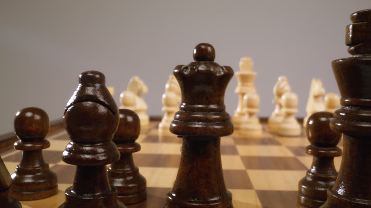 The camera slowly glides along the chess pieces of one side of the ...