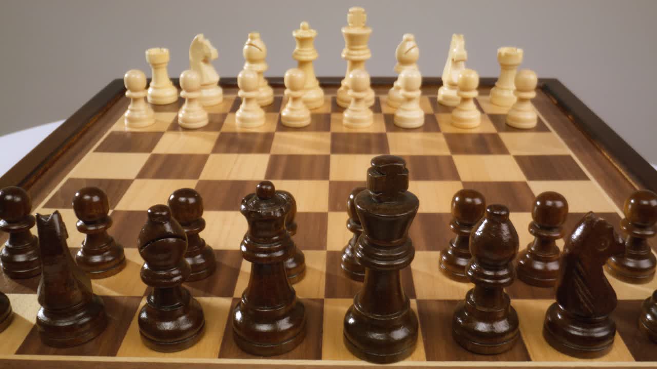 Aerial view of a chess board game with the pieces neatly arranged over ...