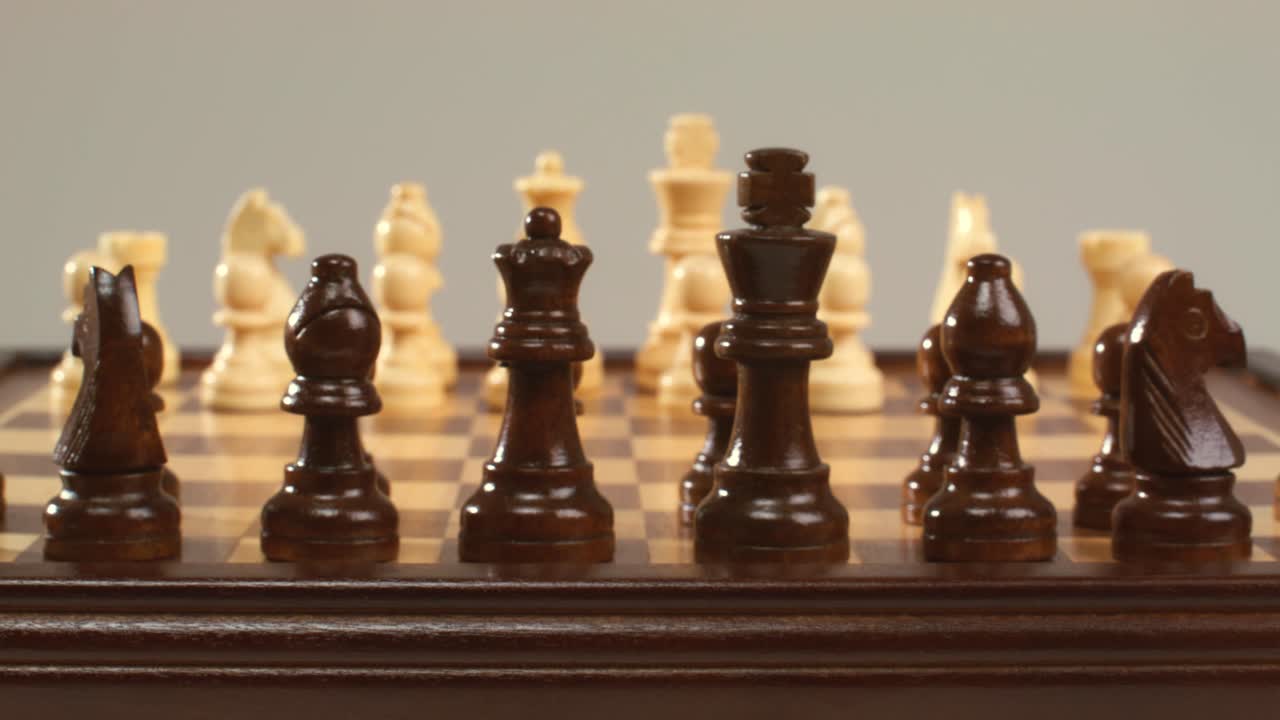 The camera glides steadily towards a chess board game featuring the ...