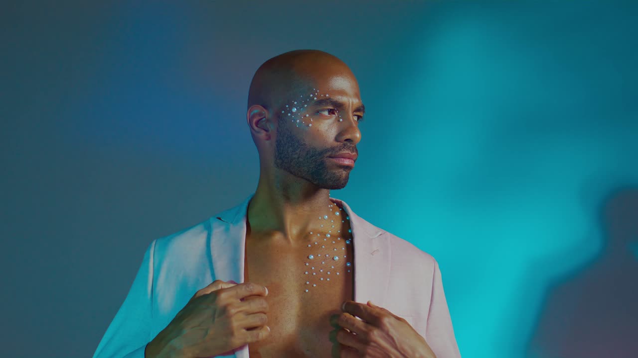 Stylish man with facial gems in a colorful suit jacket - Free Stock Video