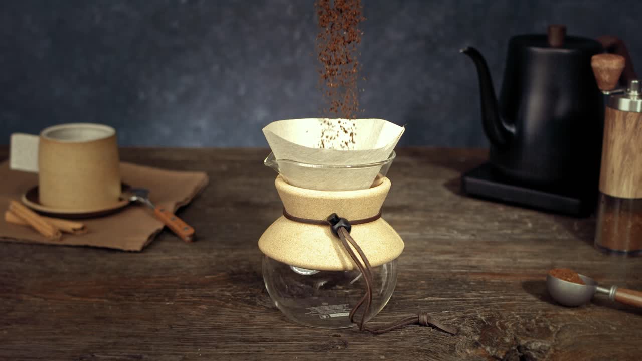 Pour-over coffee preparation setup on rustic table. - Free Stock Video
