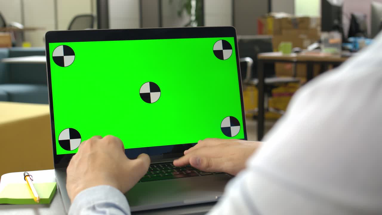 Editing a green screen laptop display in an office setting - Free Stock ...