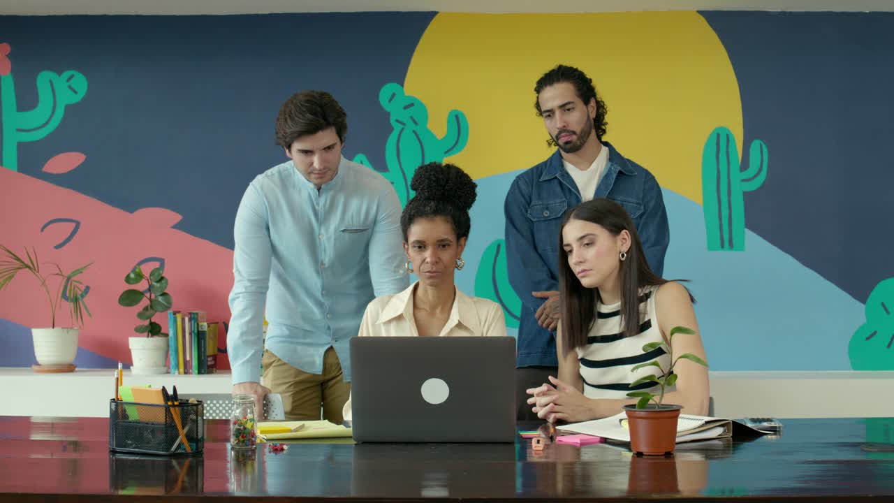 Team collaboration in a colorful workspace - Free Stock Video