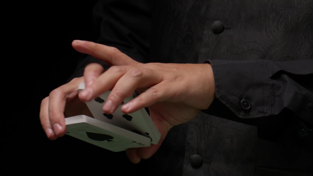 Magician performing card trick with deck of cards - Free Stock Video