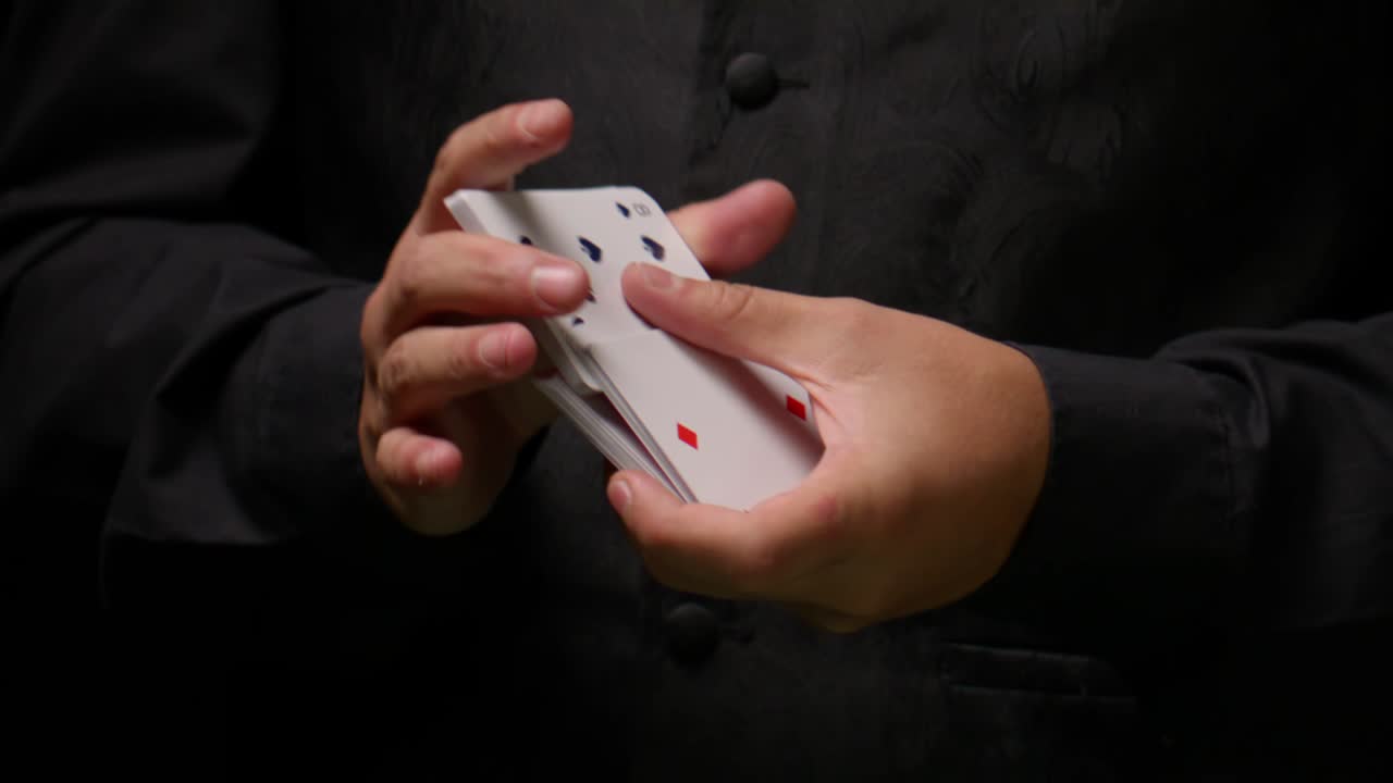 Close-up of hands shuffling playing cards - Free Stock Video