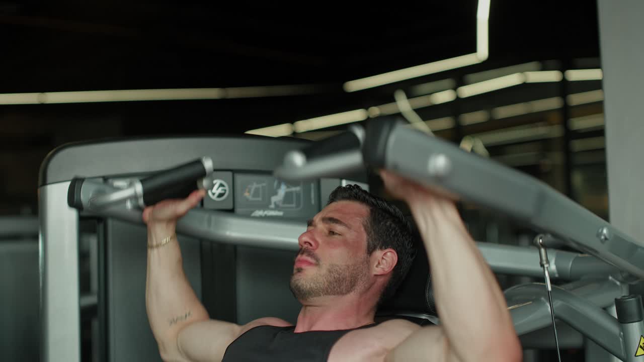 Man using chest press machine at gym - Free Stock Video