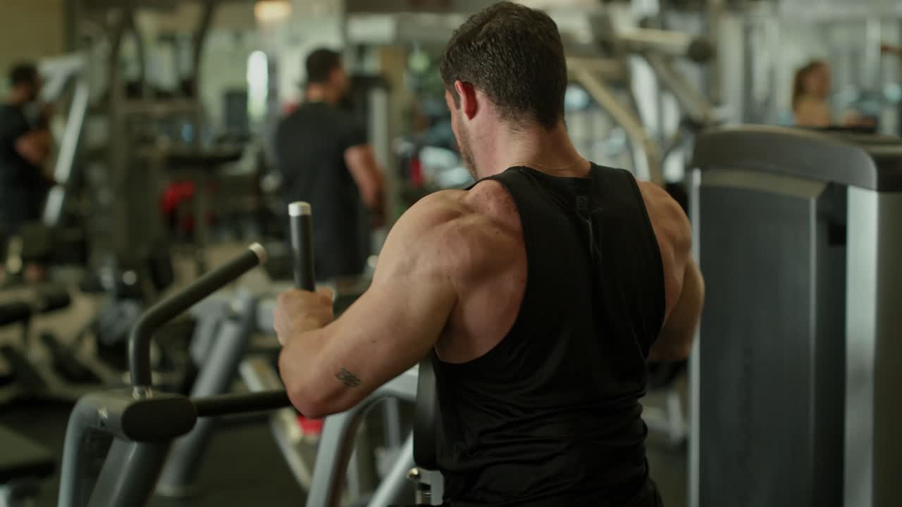 Man Building Strength on a Gym Machine - Free Stock Video