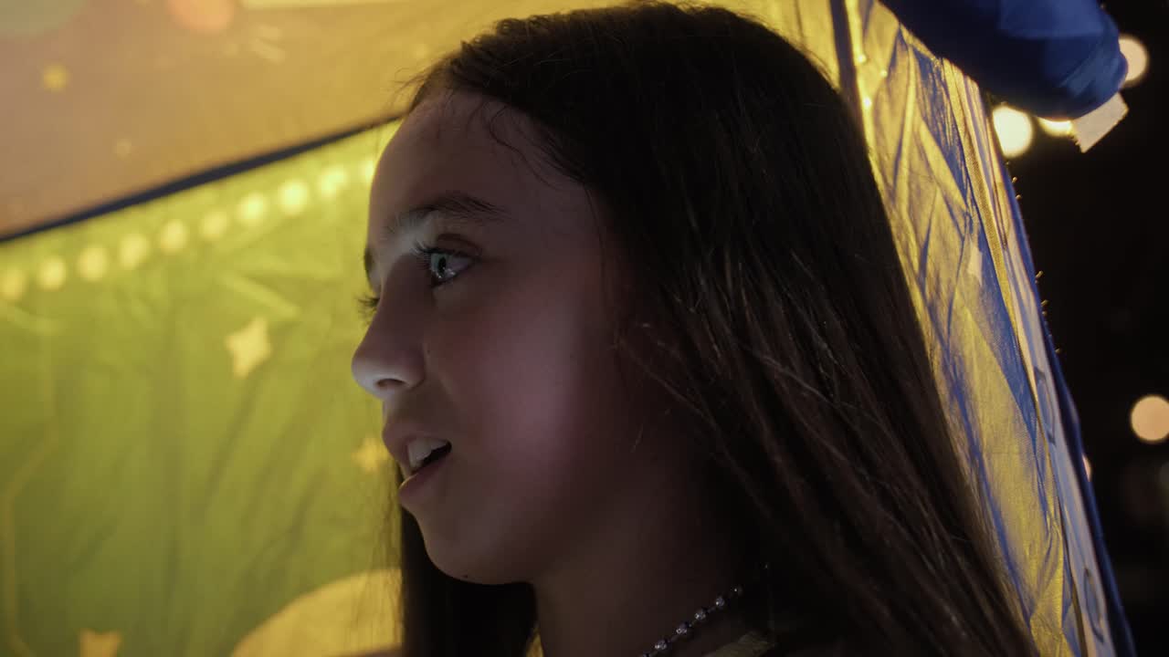 Girl glows under colorful lights with an umbrella - Free Stock Video