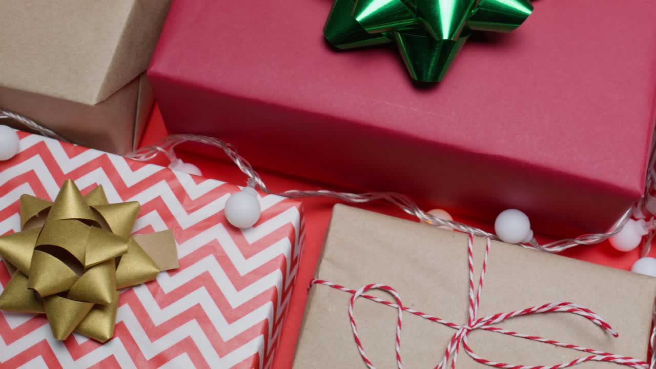Close up shot of an assortment of several Christmas gifts wrapped with ...