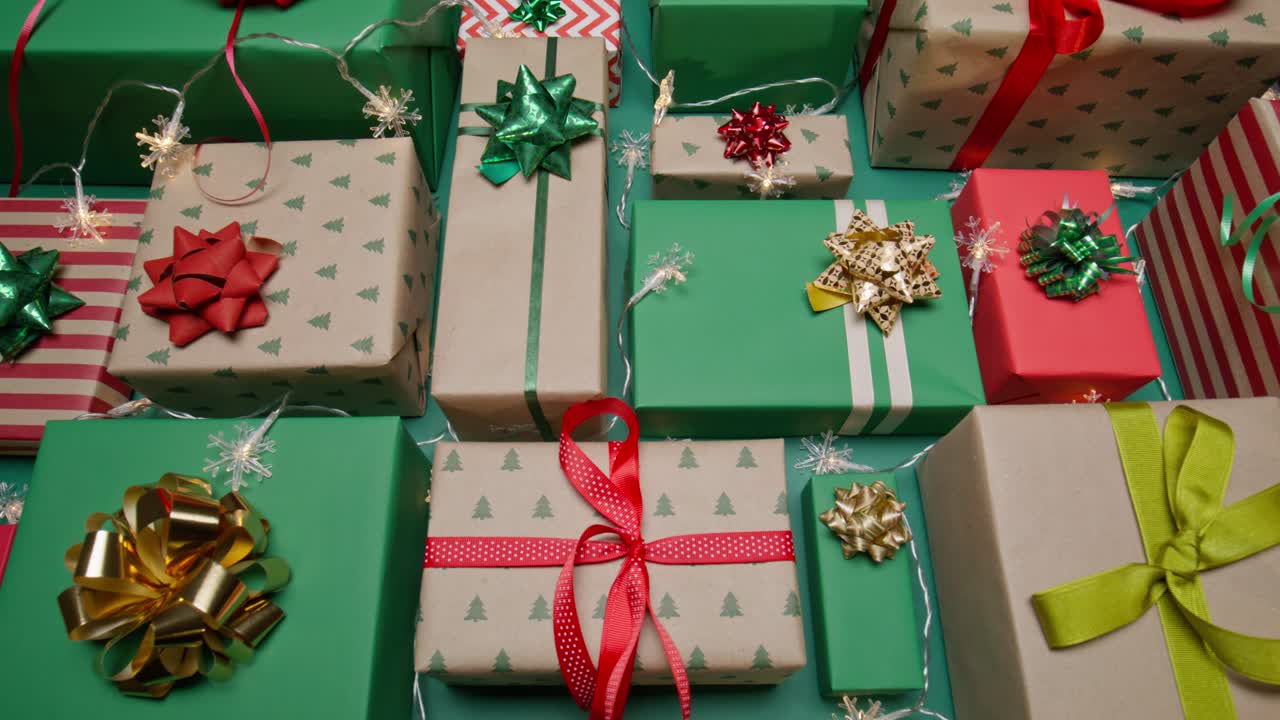 Festive array of Christmas gifts wrapped in green and red with ...