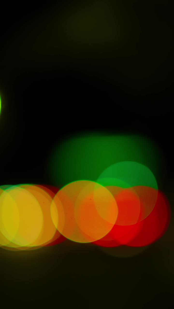 Vertical video of colorful bokeh lights on black background - Free ...