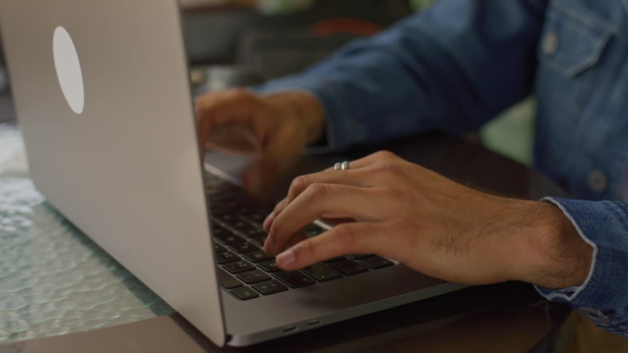 Skillful male hands adorned with rings typing on a laptop - Free Stock ...