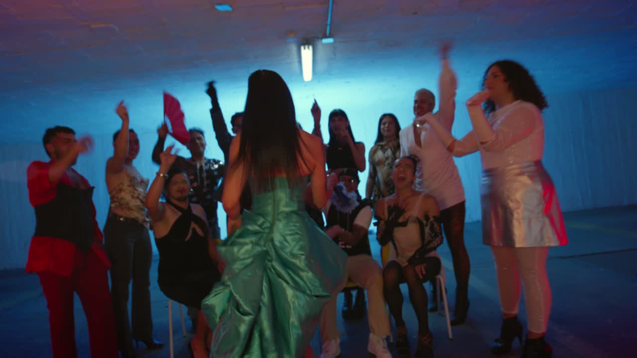 In a vibrant dance party with colorful outfits and cheering crowd a ...