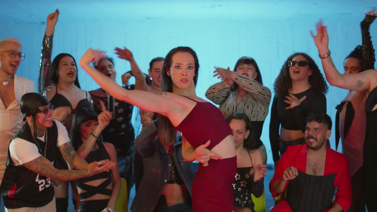 A LGBTQ dancer performing with energetic crowd cheering in the ...