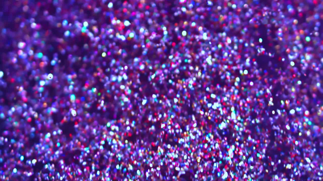 Close up of a cascade of glitter creates a mesmerizing shiny and ...