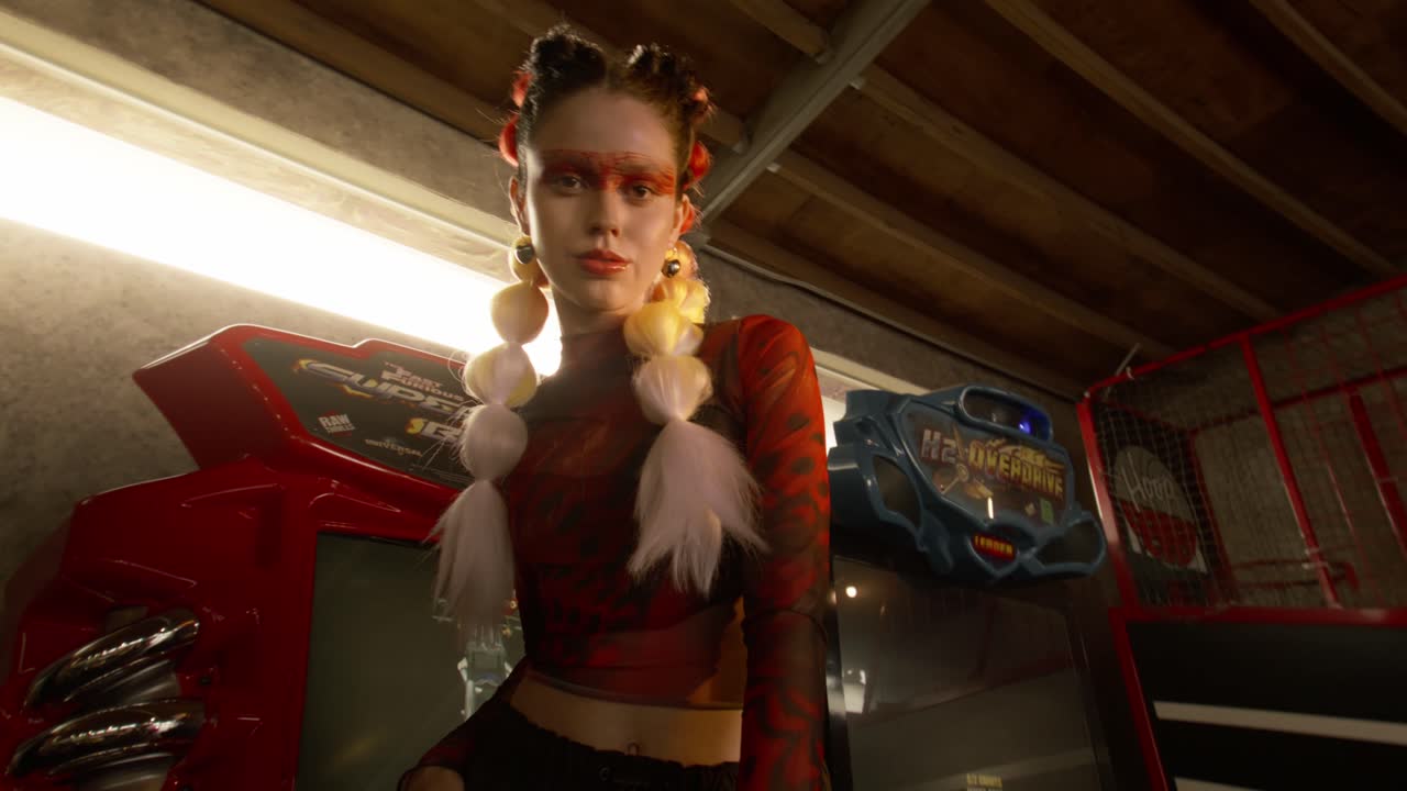 Stylish woman in a retro arcade setting - Free Stock Video