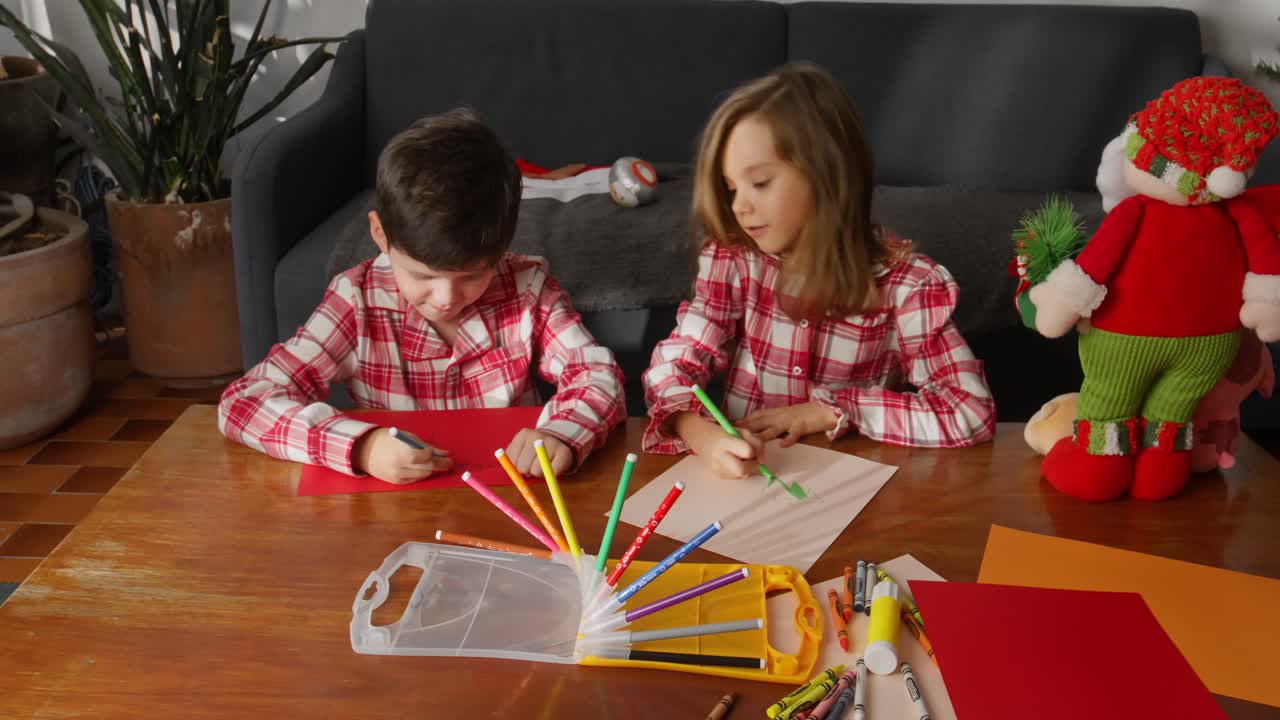 Siblings Drawing Together in Christmas - Free Stock Video