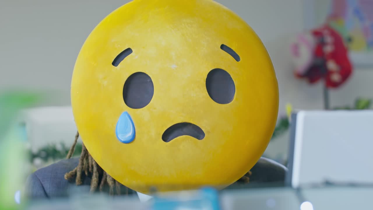 Overwhelmed Employee with Sad Emoji Head - Free Stock Video