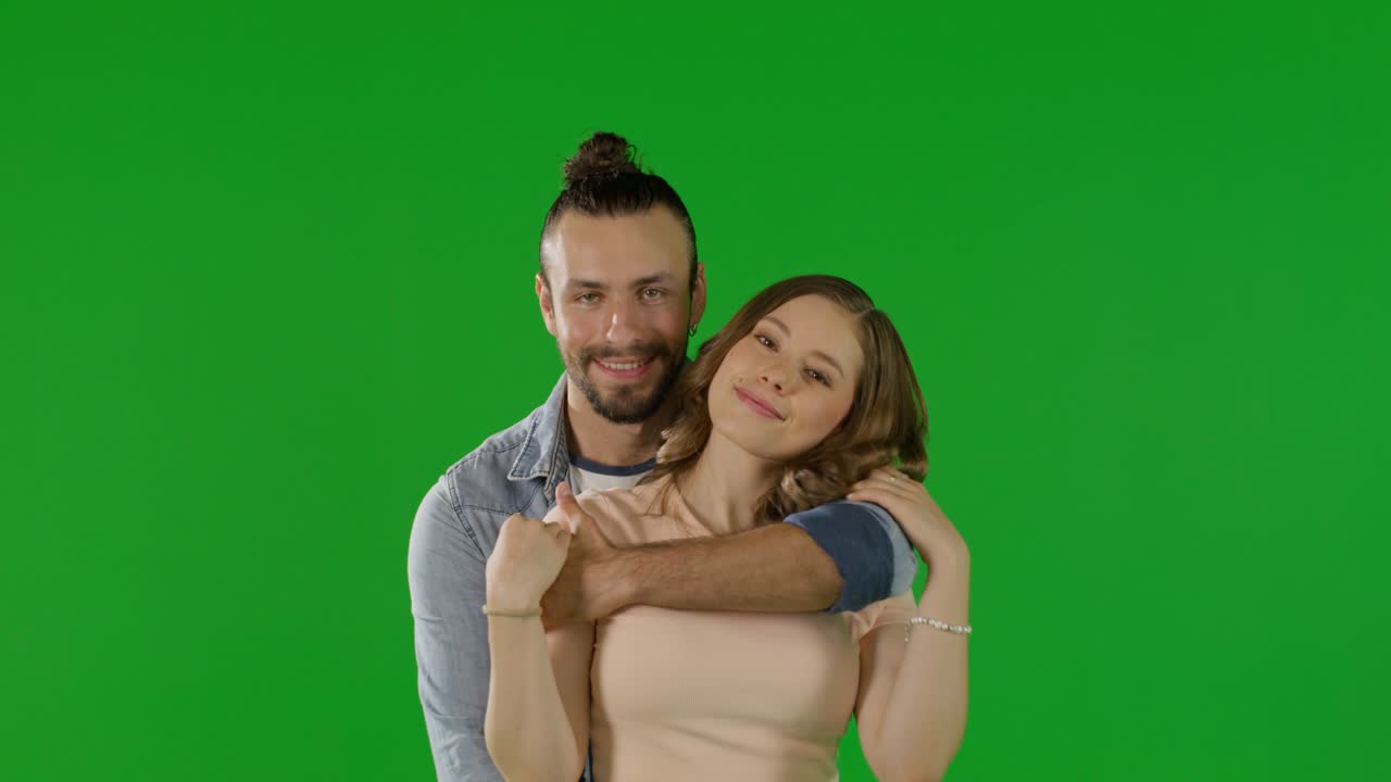 Couple embracing on a green screen background - Free Stock Video