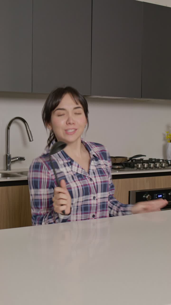 Woman Singing with a Ladle as Mic - Free Stock Video