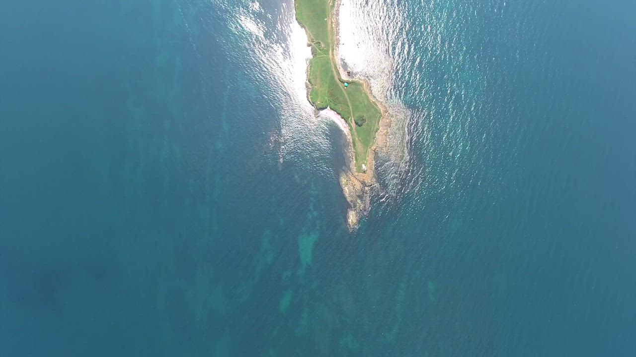 Aerial view of a peninsula and a blue ocean - Free Stock Video