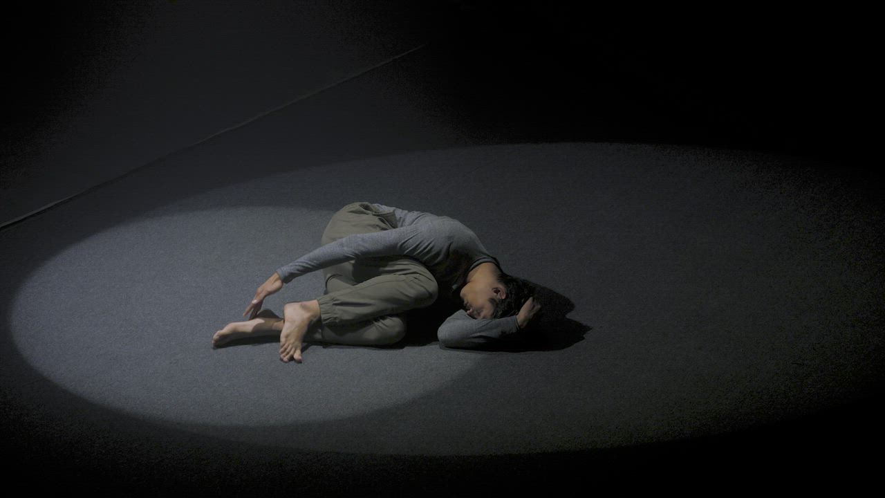 Man doing floor performance in the dark - Free Stock Video