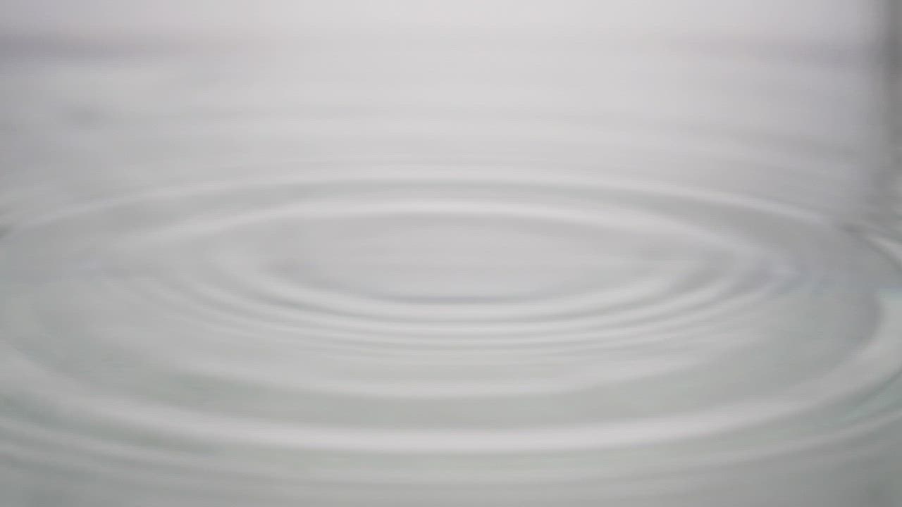 Single drops of water create ripples - Free Stock Video