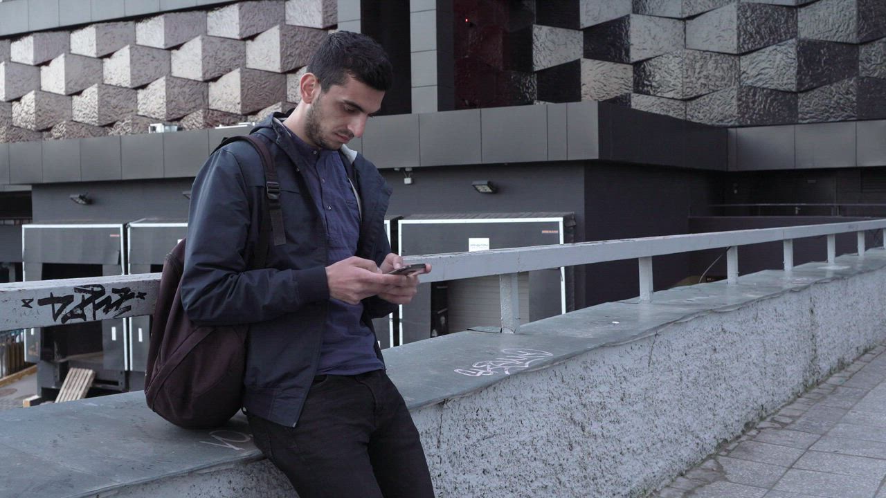 Young man texting in the city - Free Stock Video
