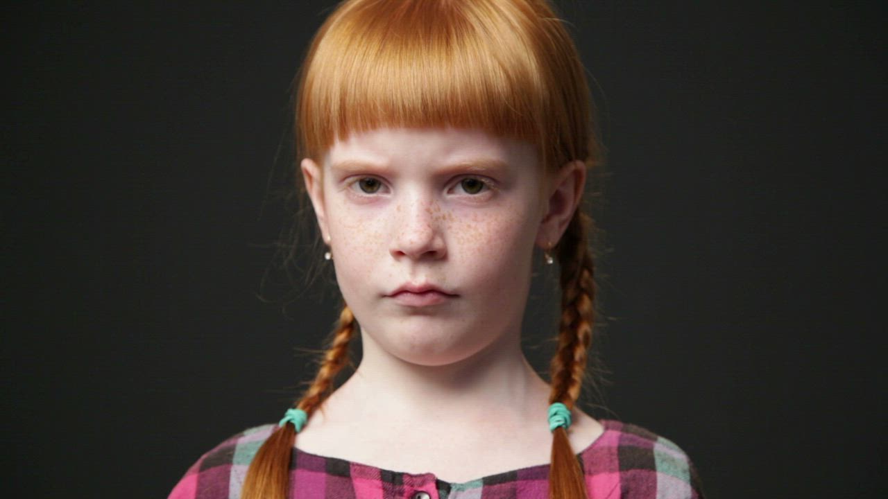 Girl with ginger hair frowning - Free Stock Video