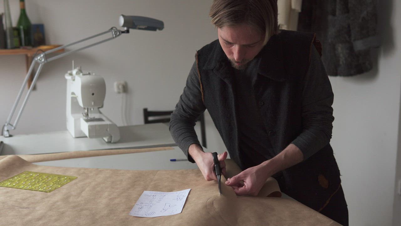 Cutting out a clothing pattern - Free Stock Video