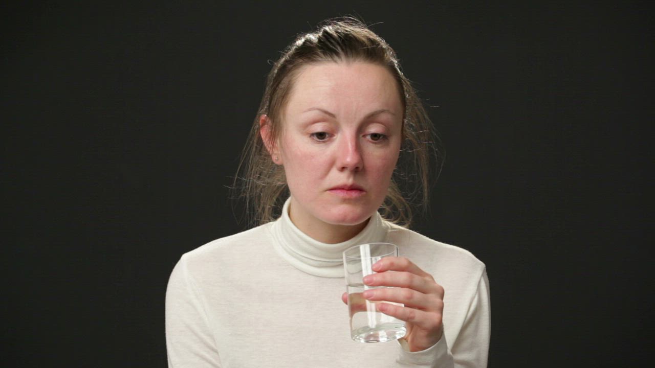 Depressed woman drinking water - Free Stock Video