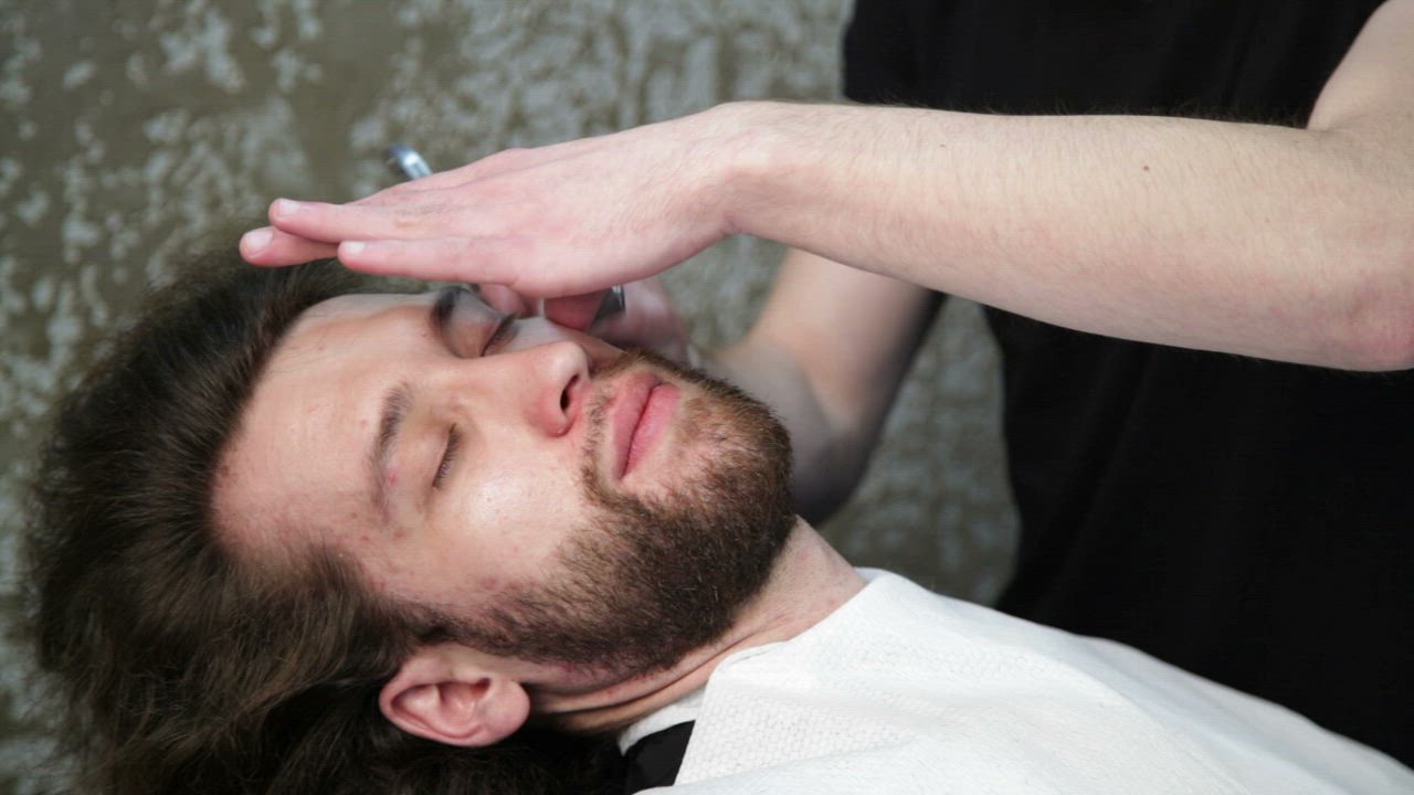 Trimming a beard with a razor - Free Stock Video