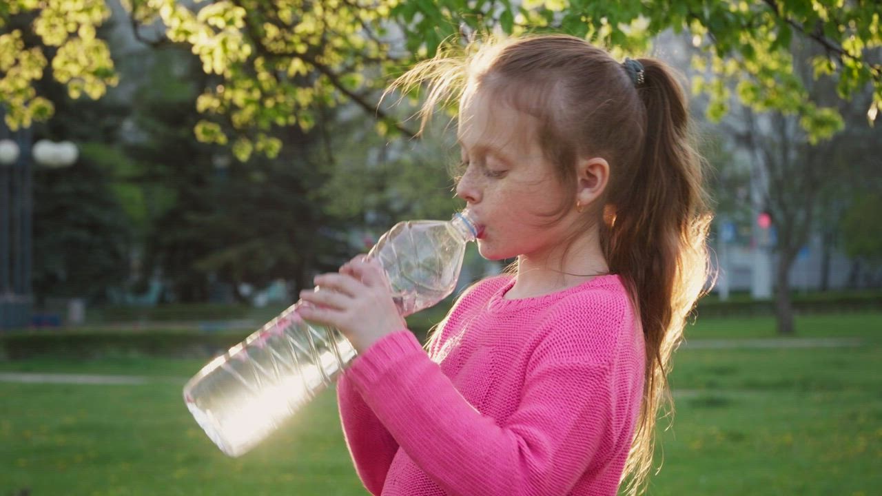 Young child with a water bottle - Free Stock Video
