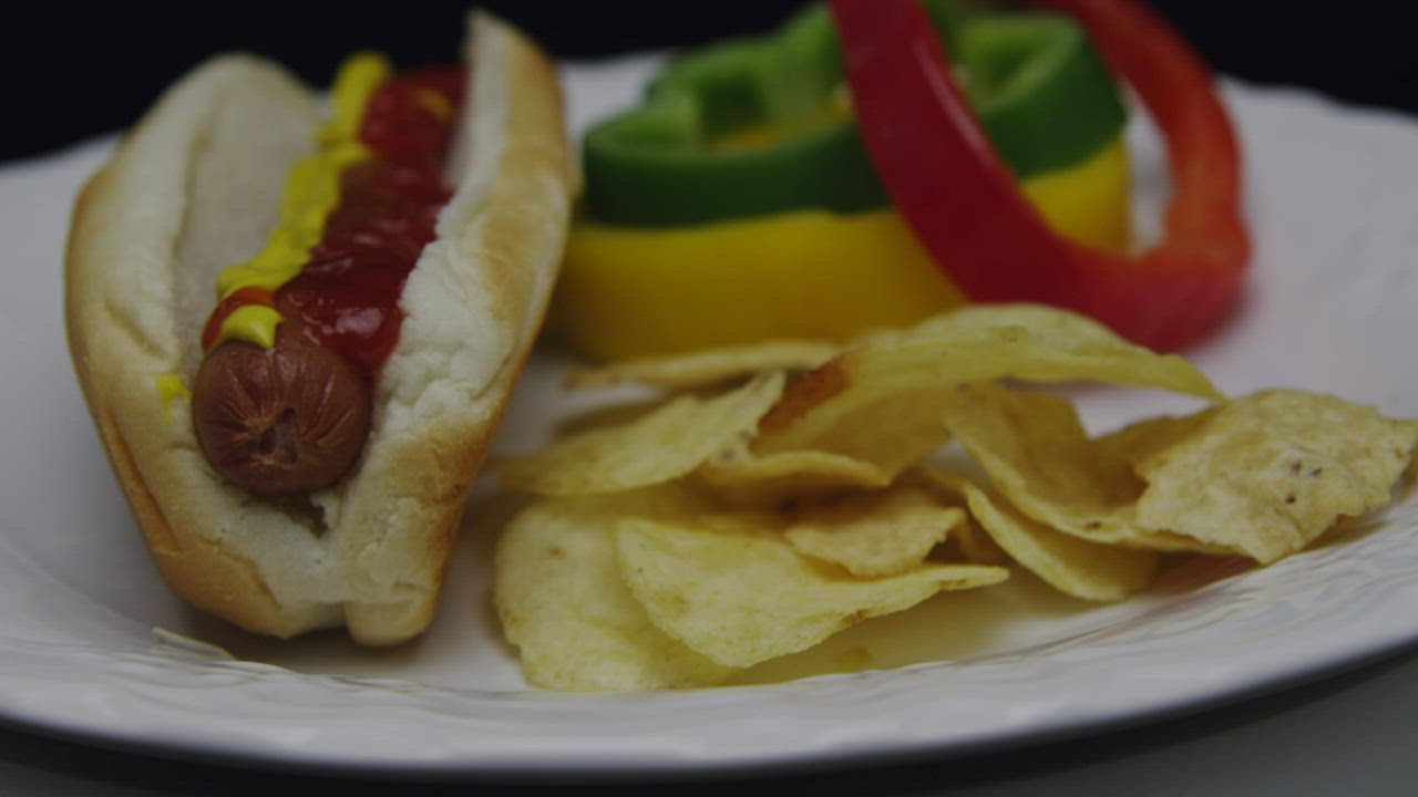 Ketchup and mustard on a hot dog - Free Stock Video