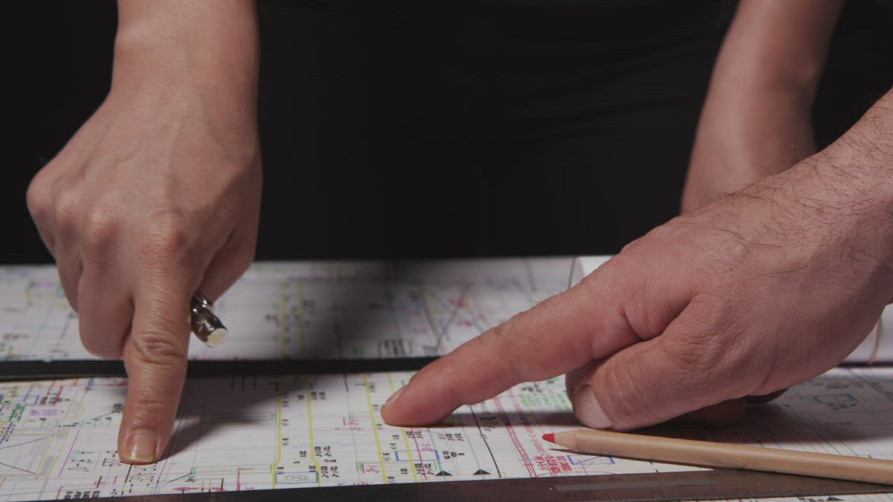 Engineers looking over plans - Free Stock Video