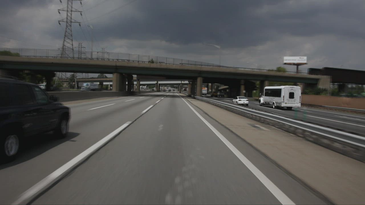 Plane flying over a highway - Free Stock Video