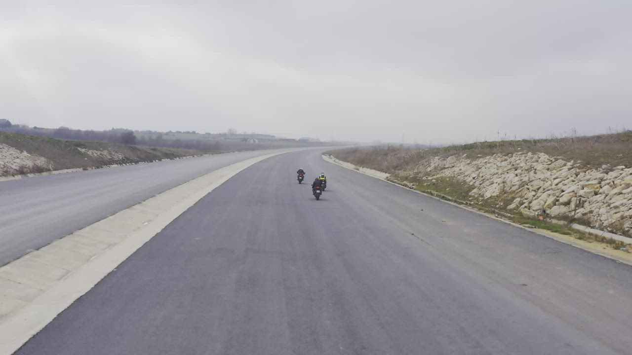 Motorcycles racing down a road - Free Stock Video