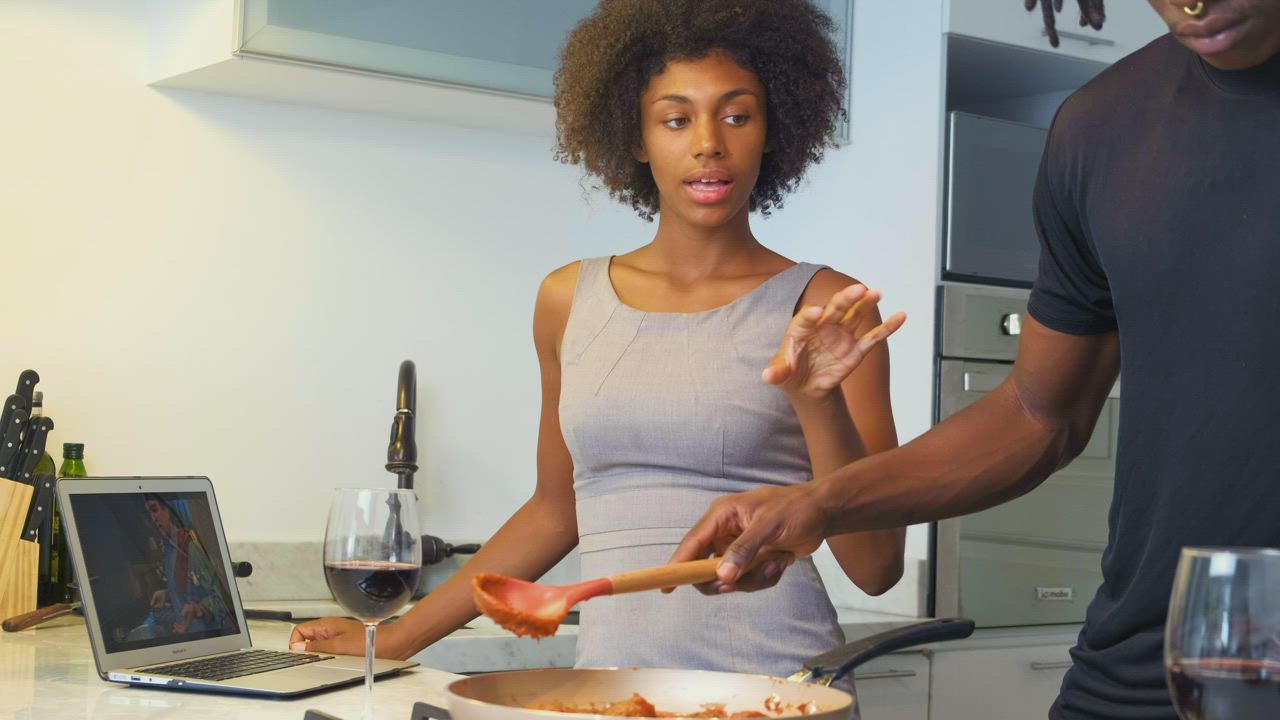 Couple preparing a dish watching a cooking tutorial - Free Stock Video