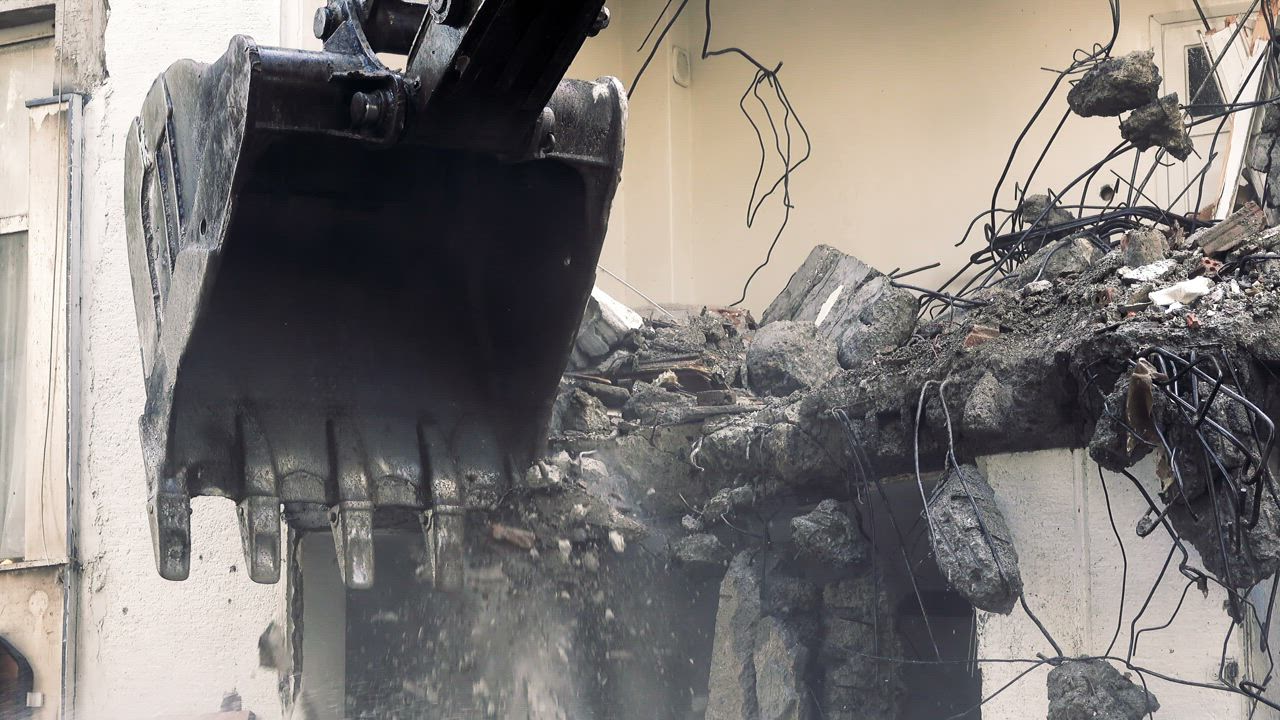 Bulldozer knocking down the structure of a ruined building - Free Stock ...