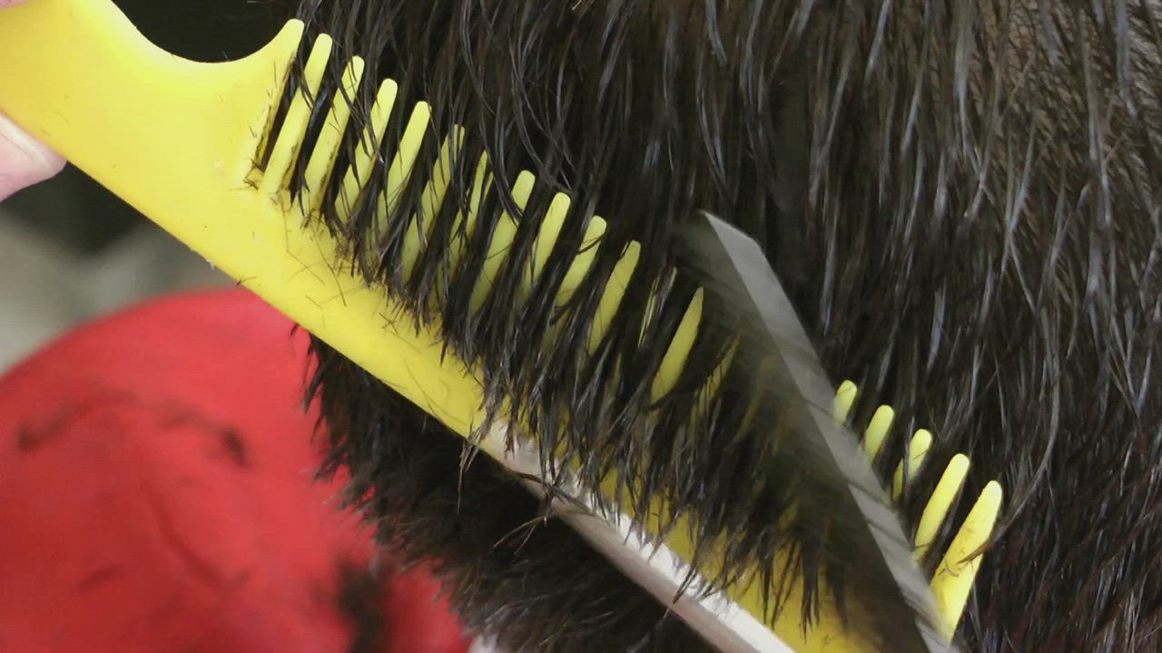 Making a haircut with scissors and comb - Free Stock Video