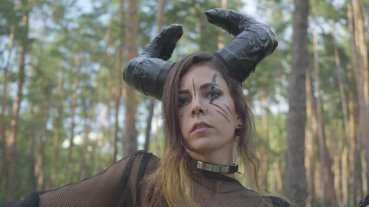 Woman dressed as devil dances in woods - Free Stock Video
