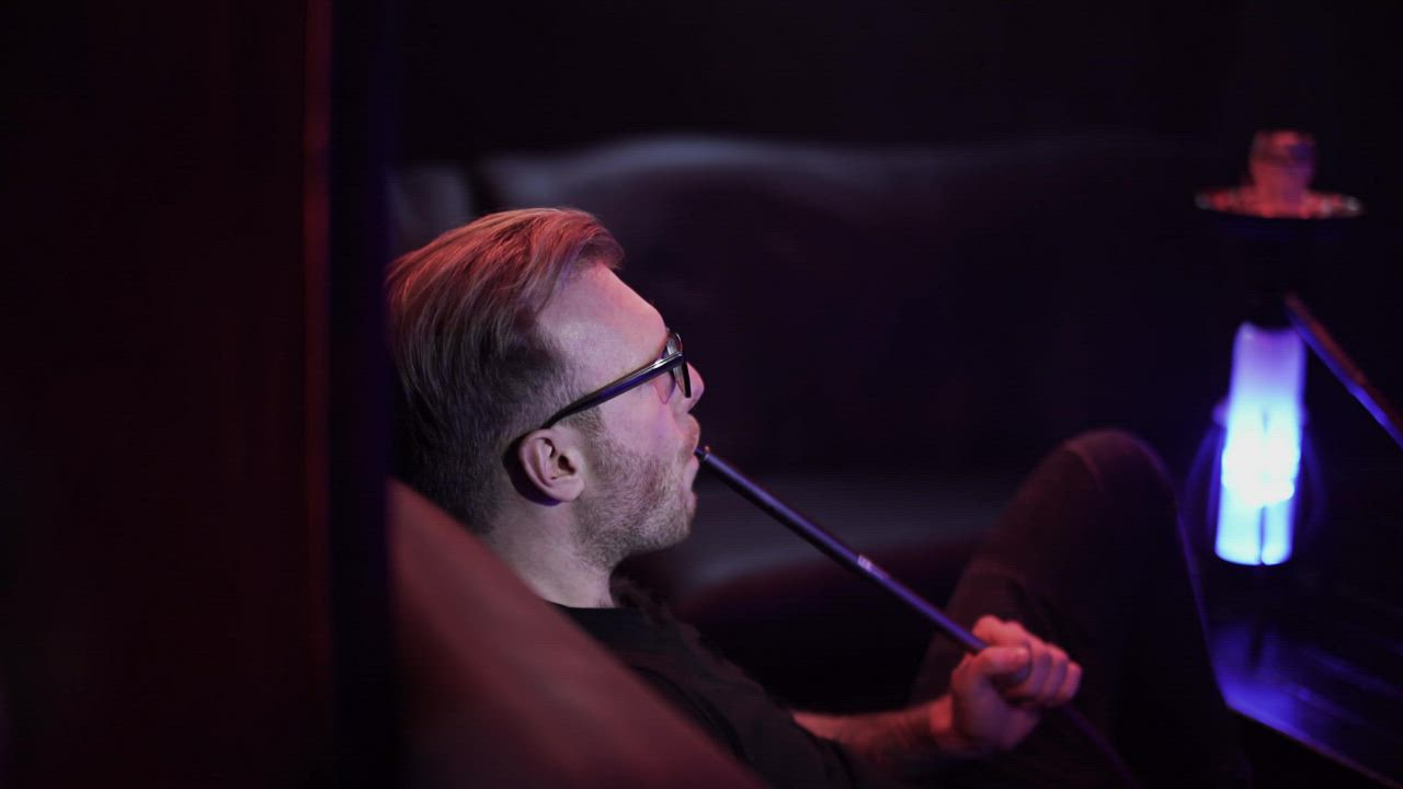 Man smoking alone in hookah club - Free Stock Video