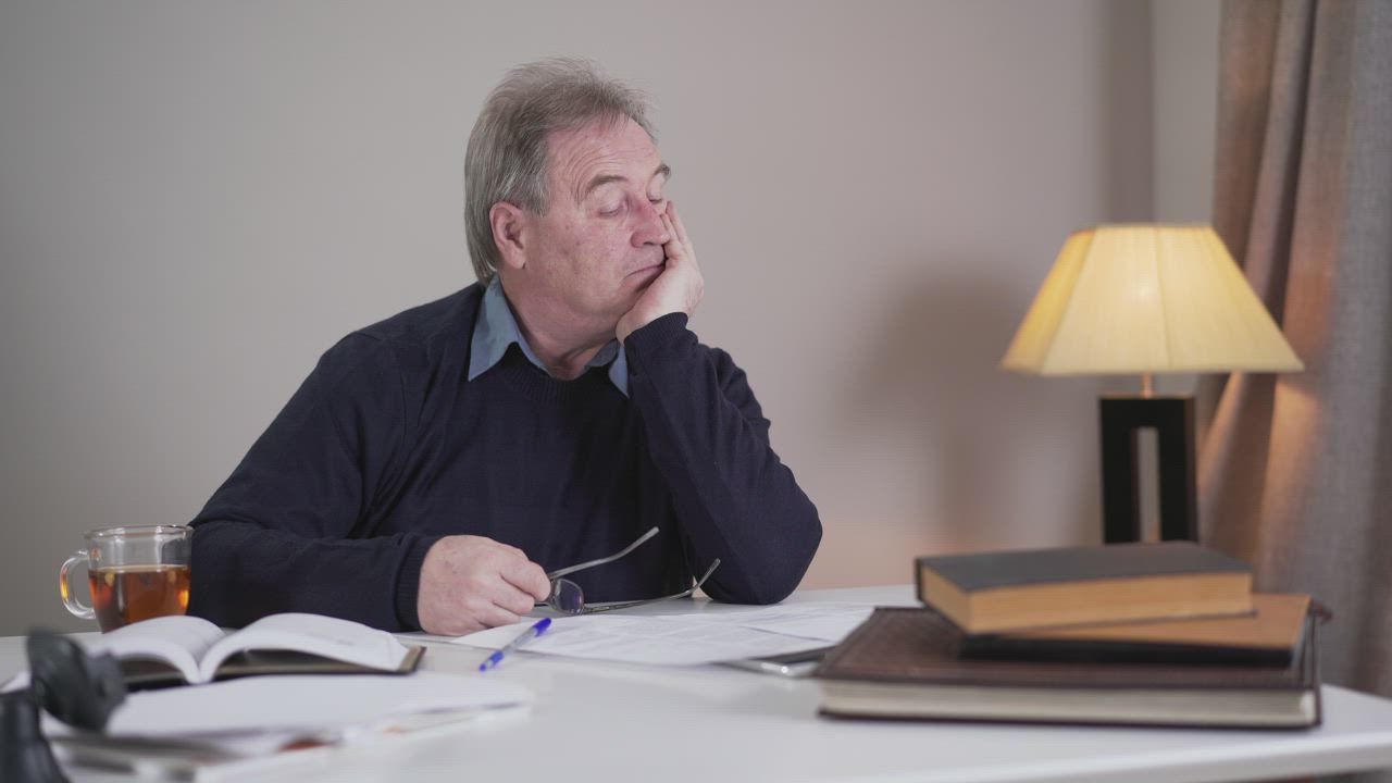 Writer looks over manuscript pages and shakes head - Free Stock Video